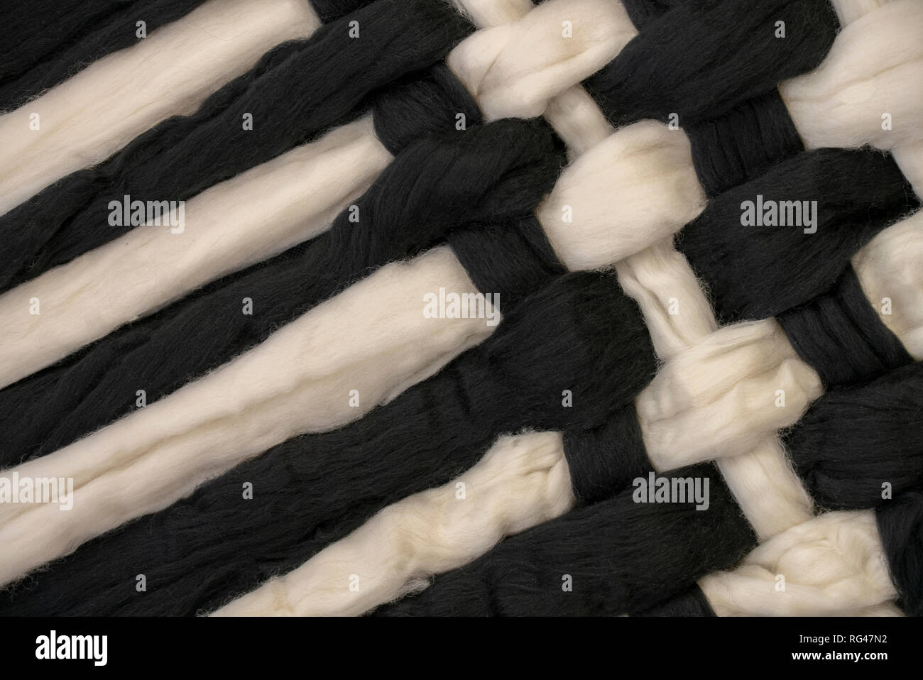Intertwined black and white tufts of wool. Conceptual photo Stock Photo ...