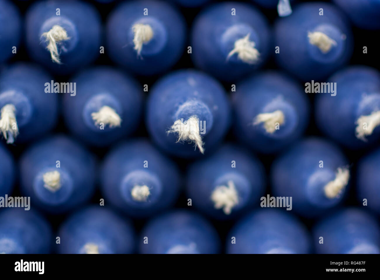 stack of brightly colored blue candles Stock Photo - Alamy