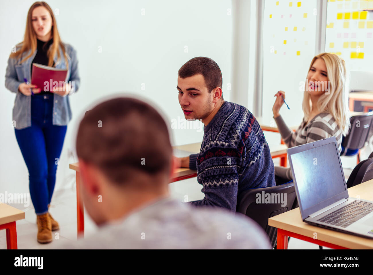 Group of teens are on class, smiling and talking Stock Photo - Alamy