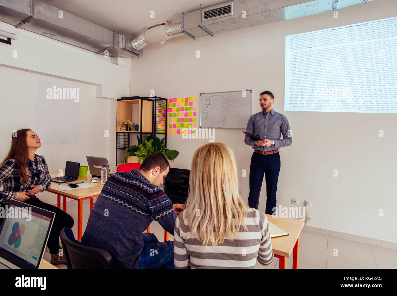 Young male student is reading a script in front of the class Stock ...