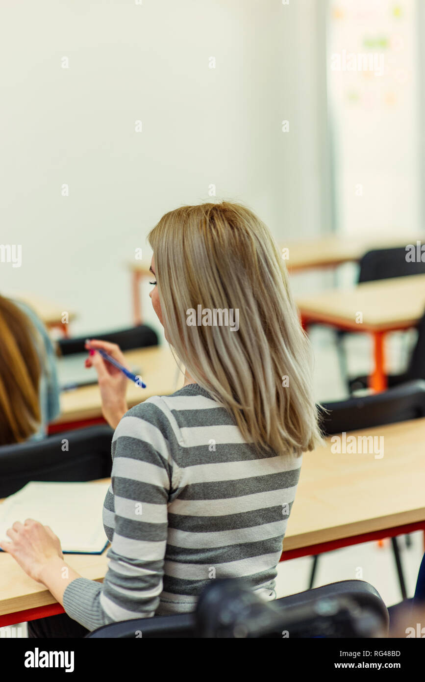 Young student in classroom, she is looking interested Stock Photo - Alamy