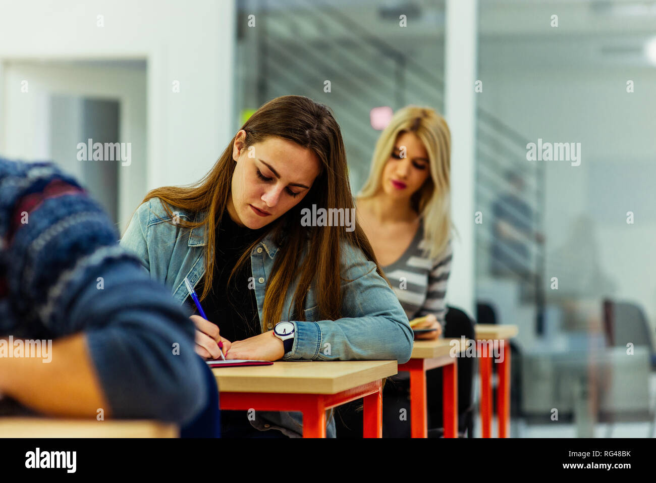 School and education concept - group of tired students with notebooks ...