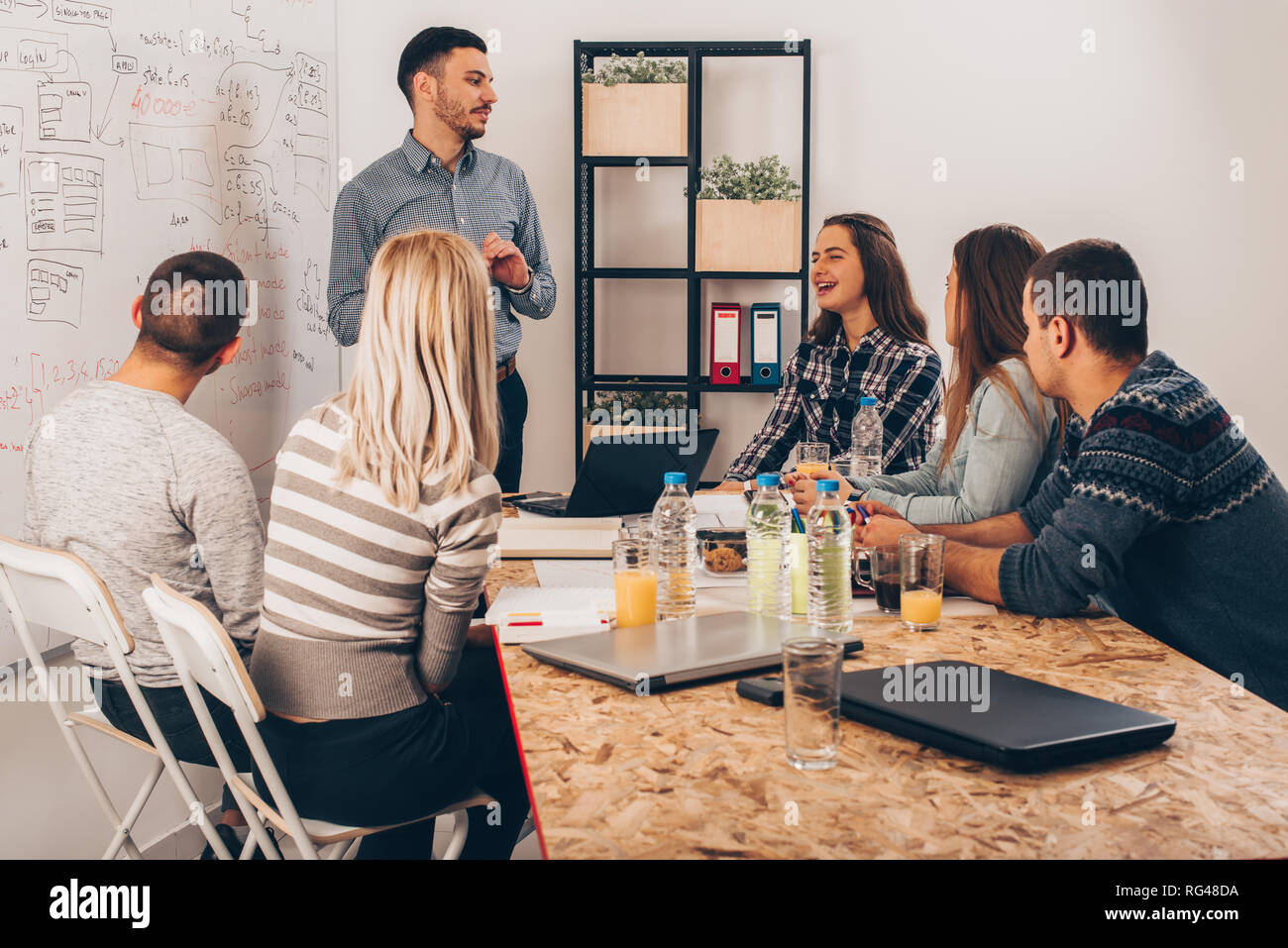 Group of young people are disscusing on the table on their workplace ...