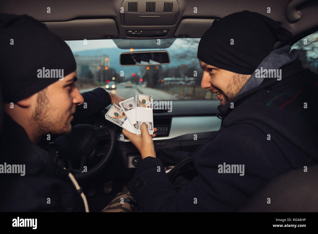 After the successful bank robbery, the thieves are sitting in the car ...
