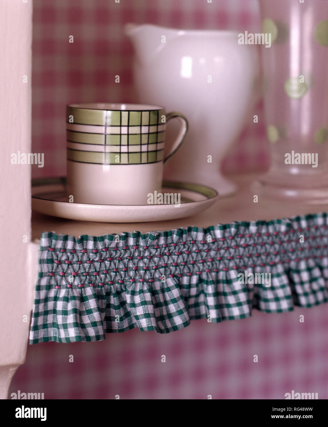 Smocked checked trimming on shelf with crockery Stock Photo - Alamy