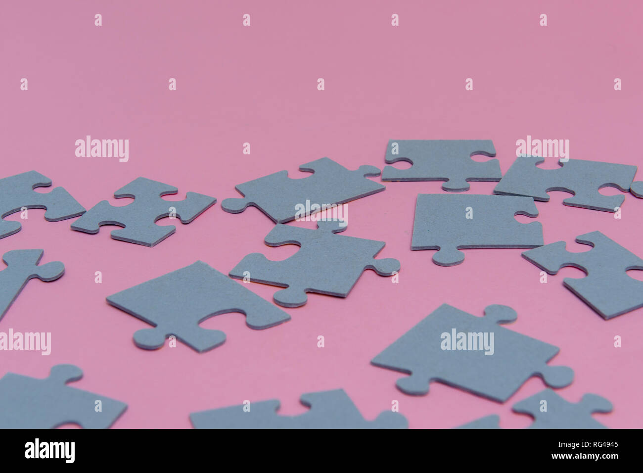 Puzzles on a pink background as a symbol of autism. Conceptual vision ...
