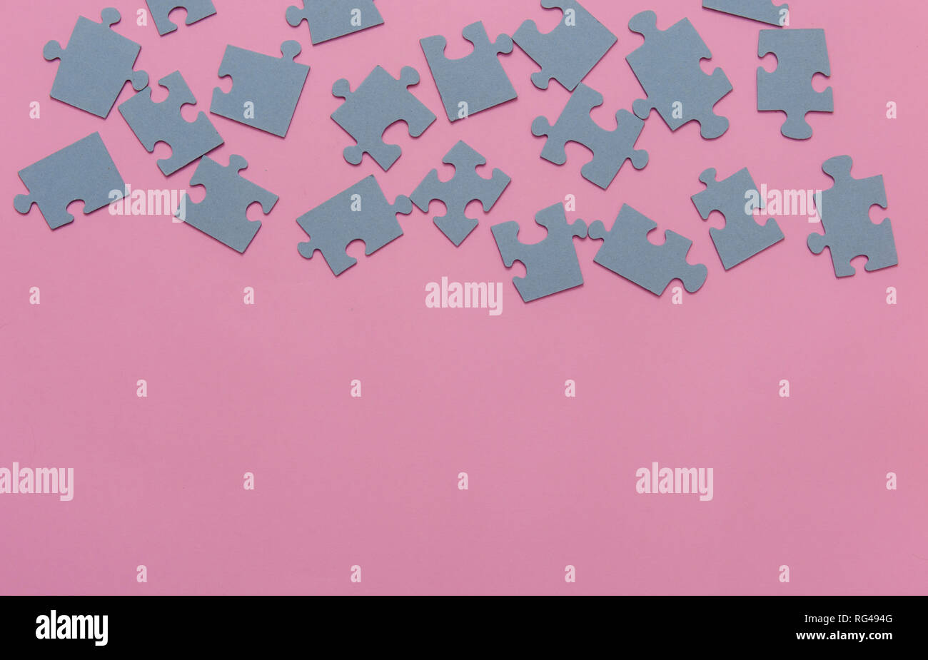 Puzzles on a pink background as a symbol of autism. Conceptual vision ...
