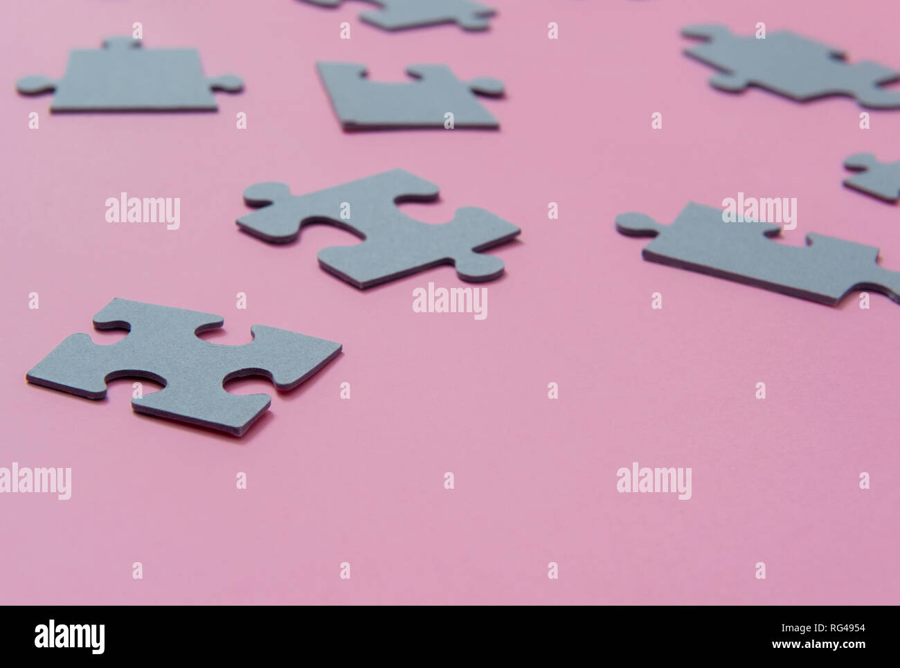 Puzzles on a pink background as a symbol of autism. Conceptual vision ...