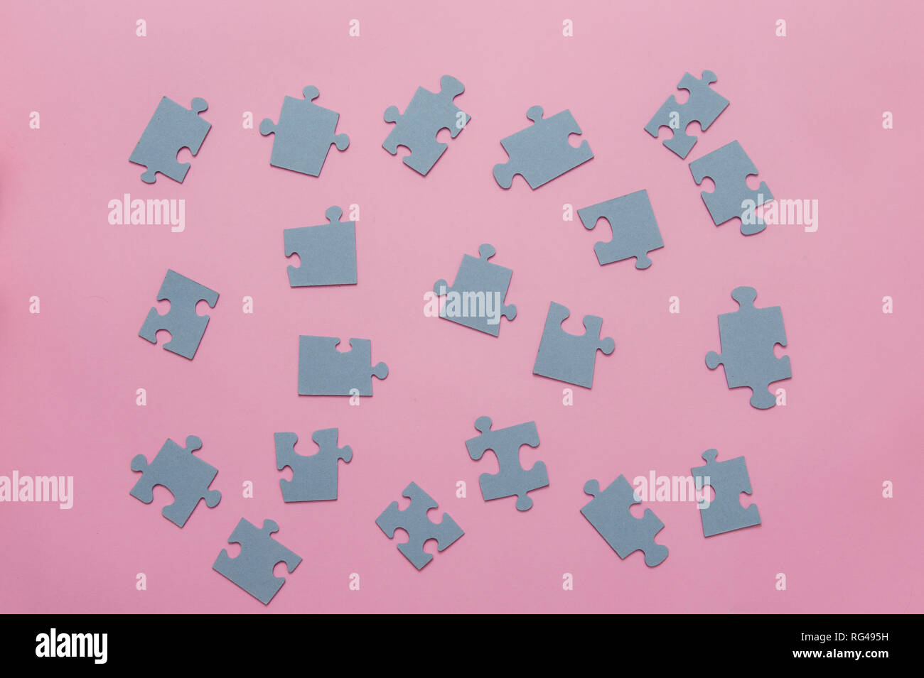 Puzzles on a pink background as a symbol of autism. Conceptual vision ...