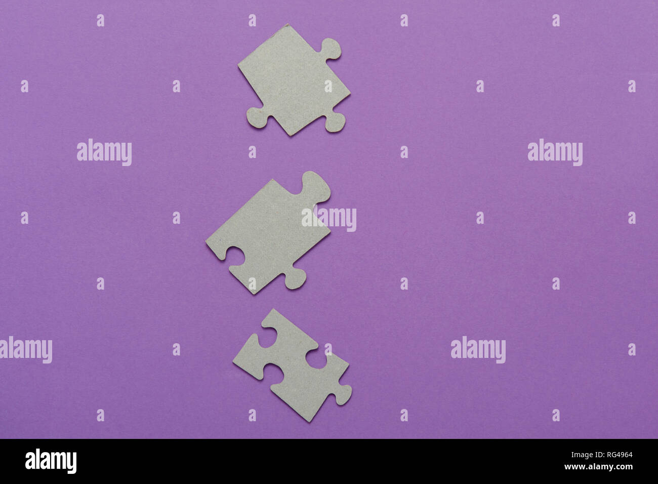 Puzzles on a purple background as a symbol of autism. Conceptual vision ...