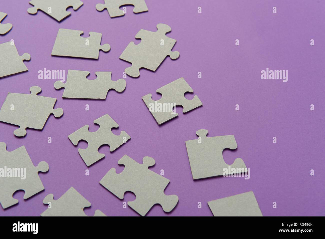 Puzzles on a purple background as a symbol of autism. Conceptual vision ...