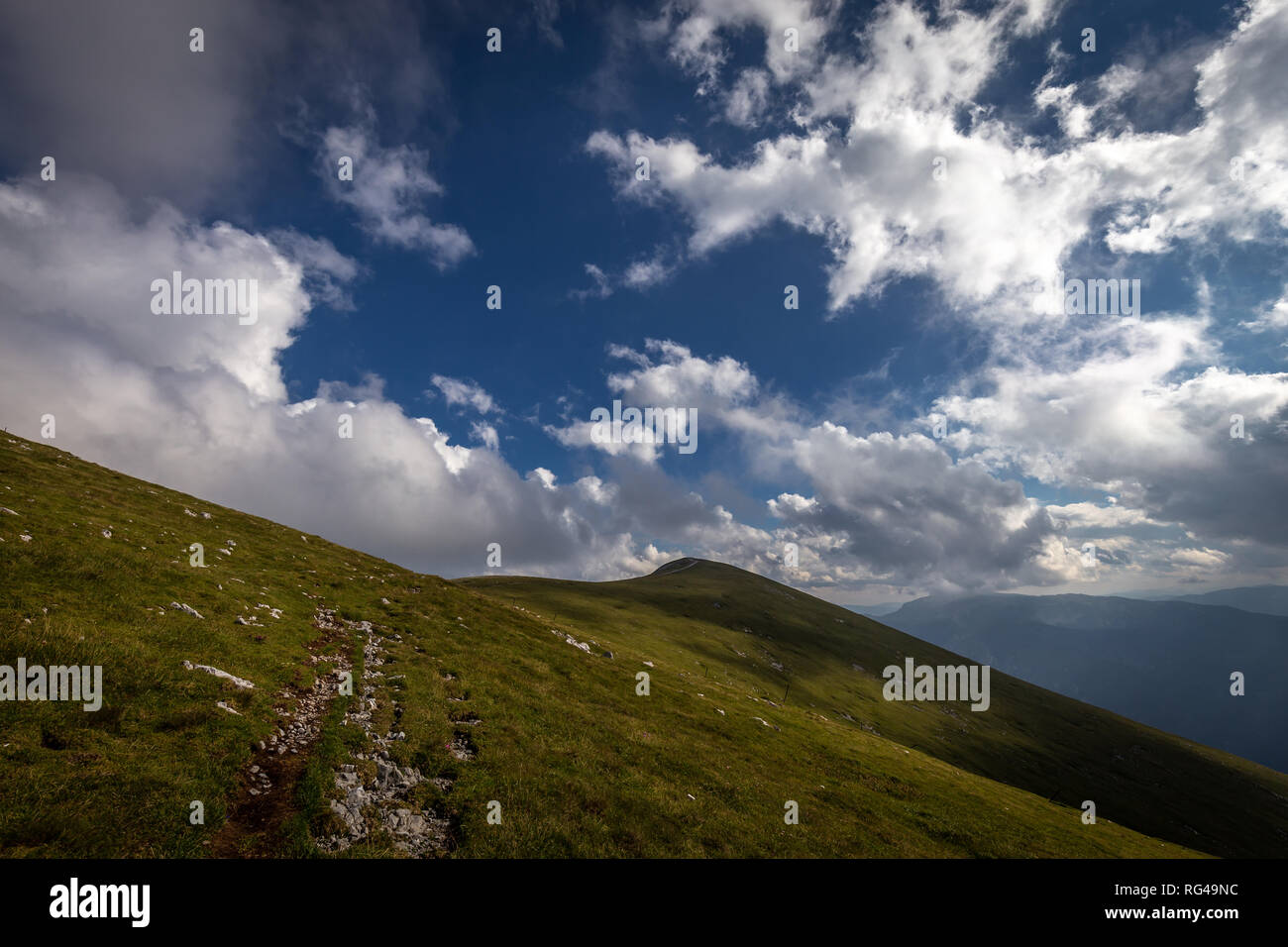 Rocky path in the fresh, green, grassy Rax plateau with and dramatic ...