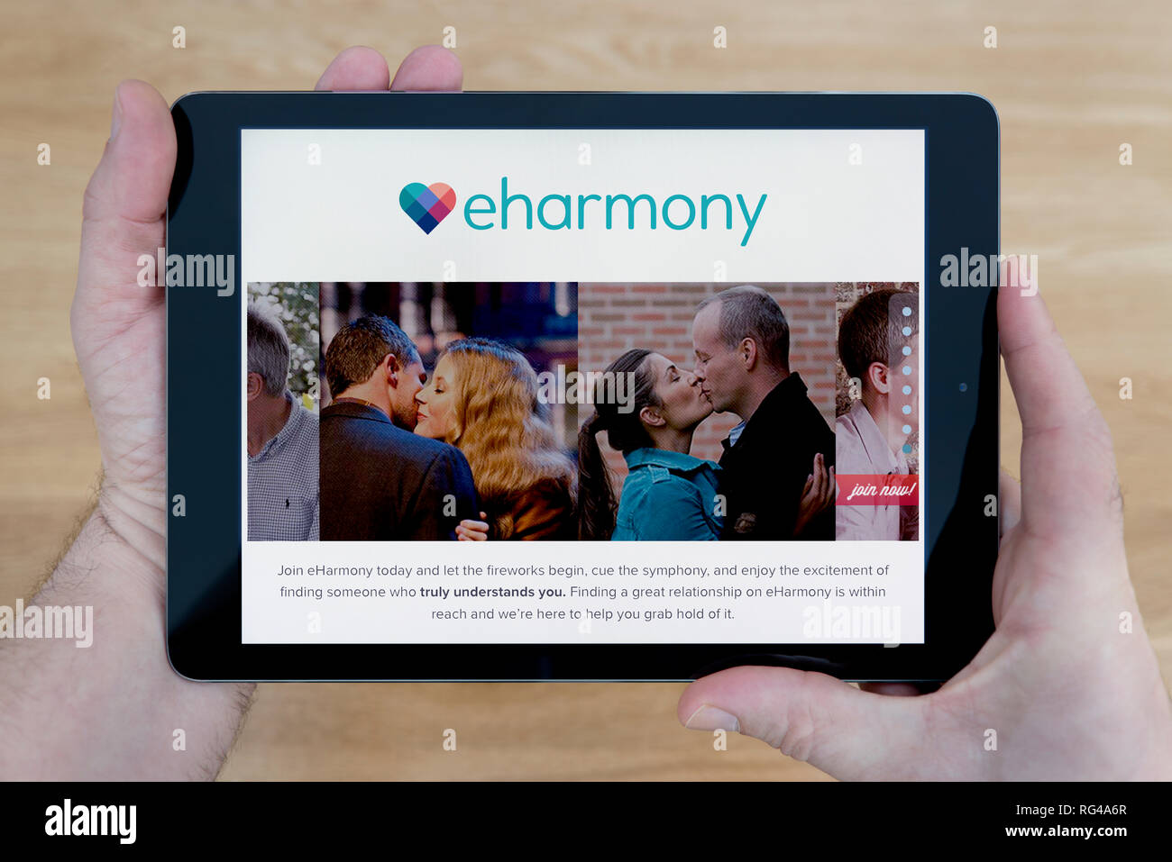A man looks at the eharmony website on his iPad tablet device, shot ...