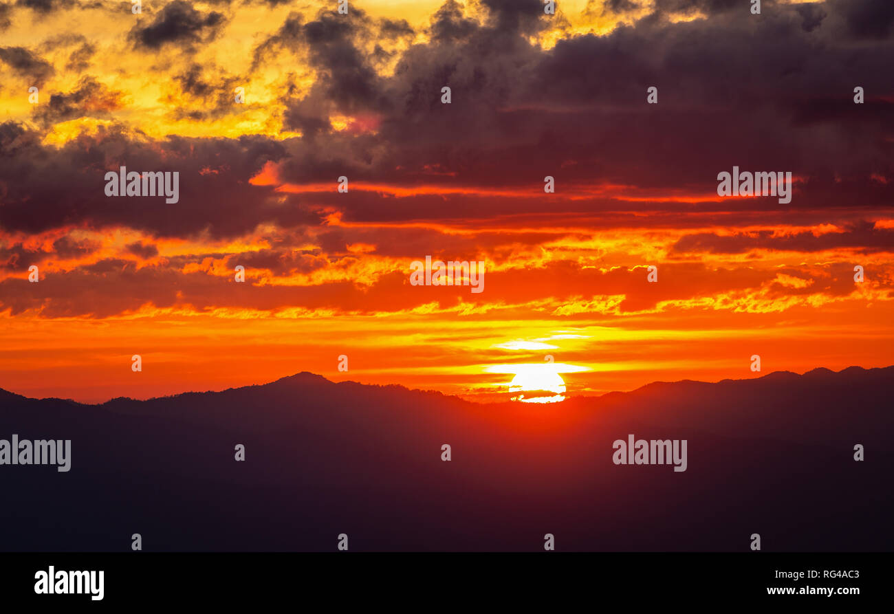 Dramatic cloudy sky changing light to orange during sunset over ...
