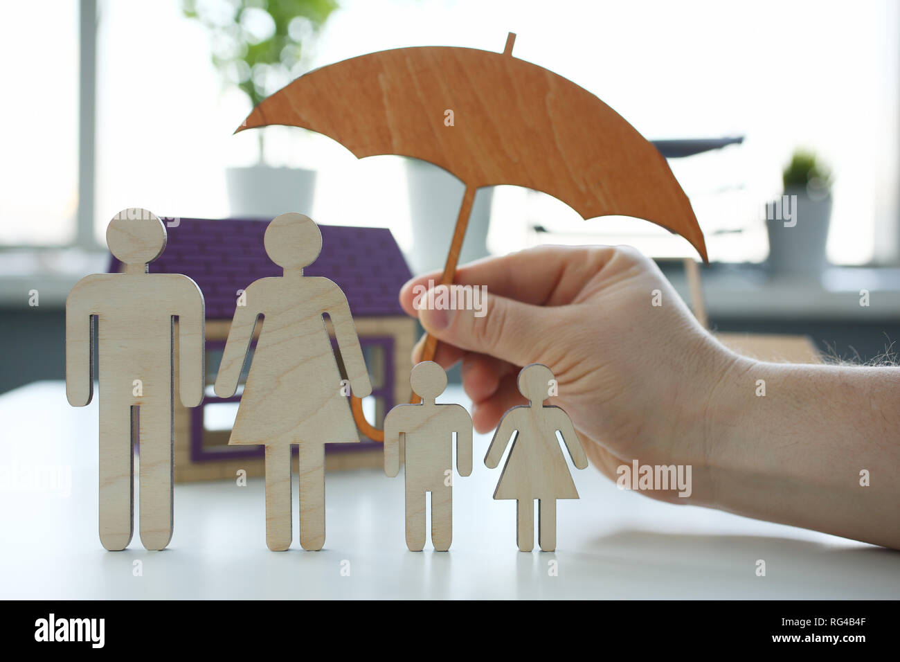 Male insurance agent hold hands gesture shield Stock Photo - Alamy