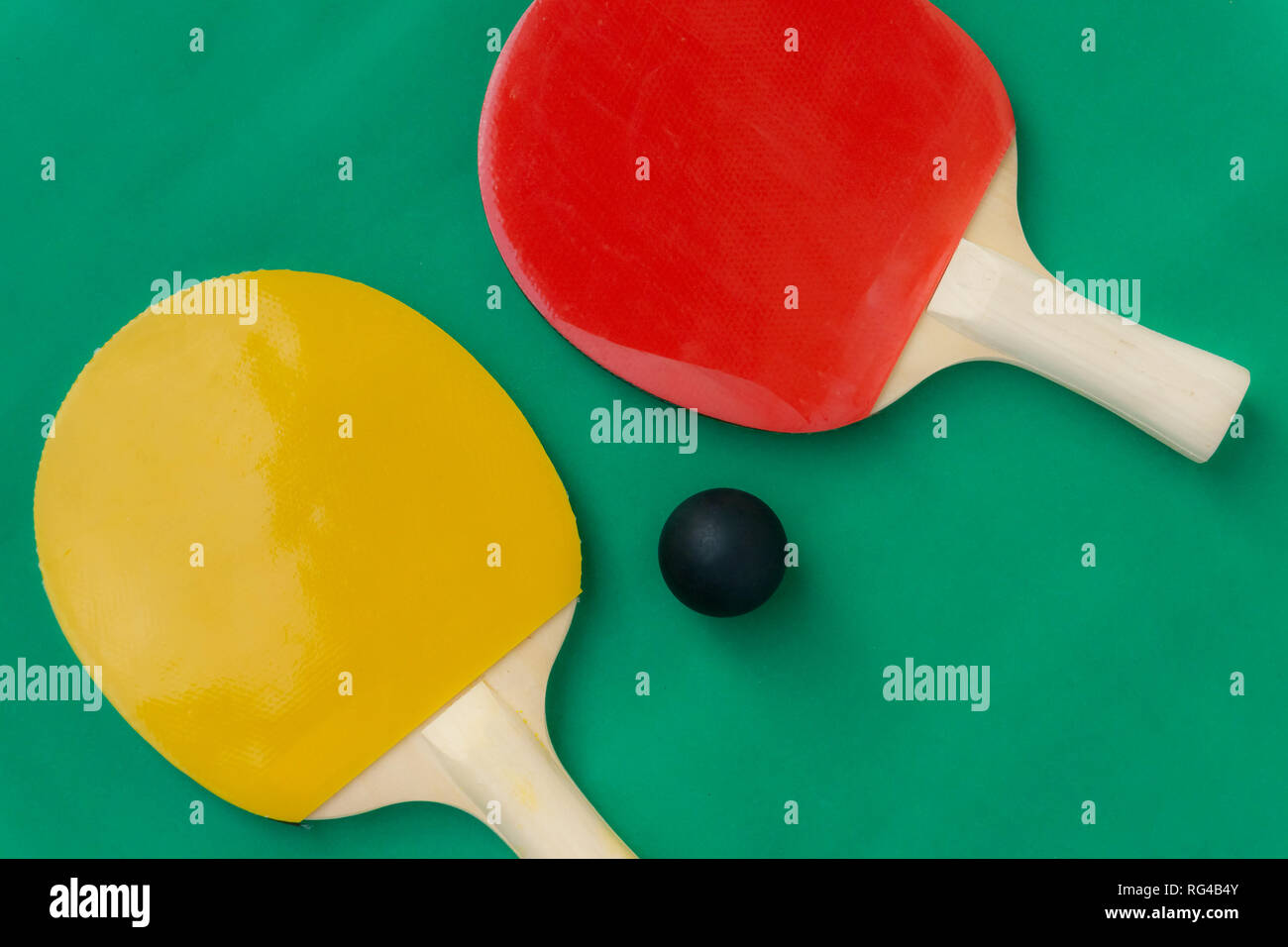 Red and yellow table tennis rackets with black balls, table tennis ...
