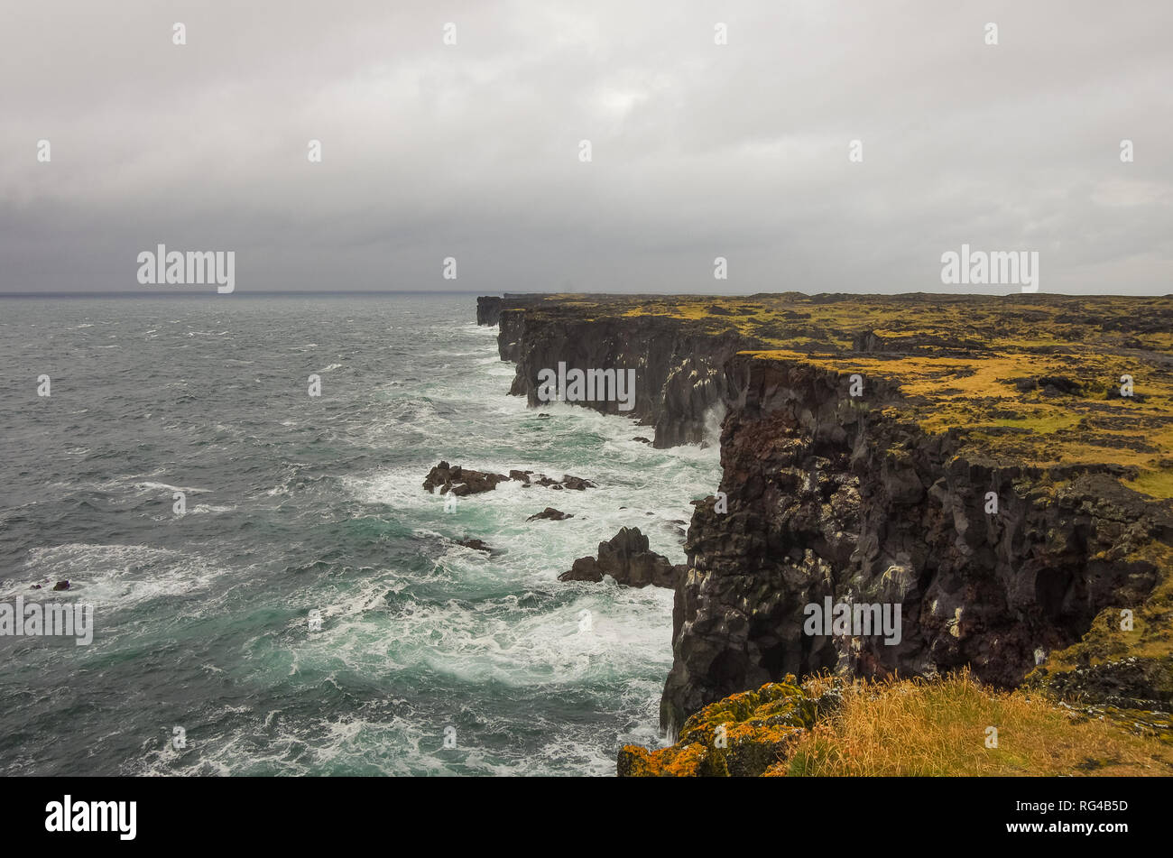 Atlantic ocean and black rock cliff of western Iceland coast ...