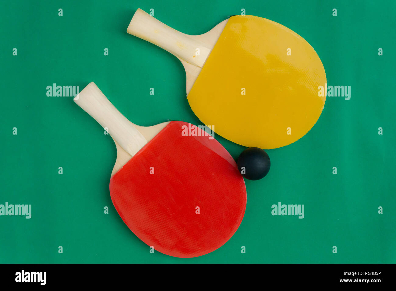 Red and yellow table tennis rackets with black balls, table tennis ...