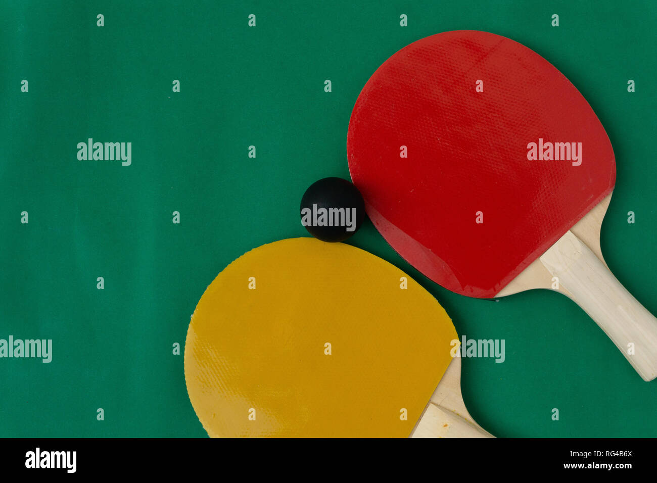 Red and yellow table tennis rackets with black balls, table tennis ...