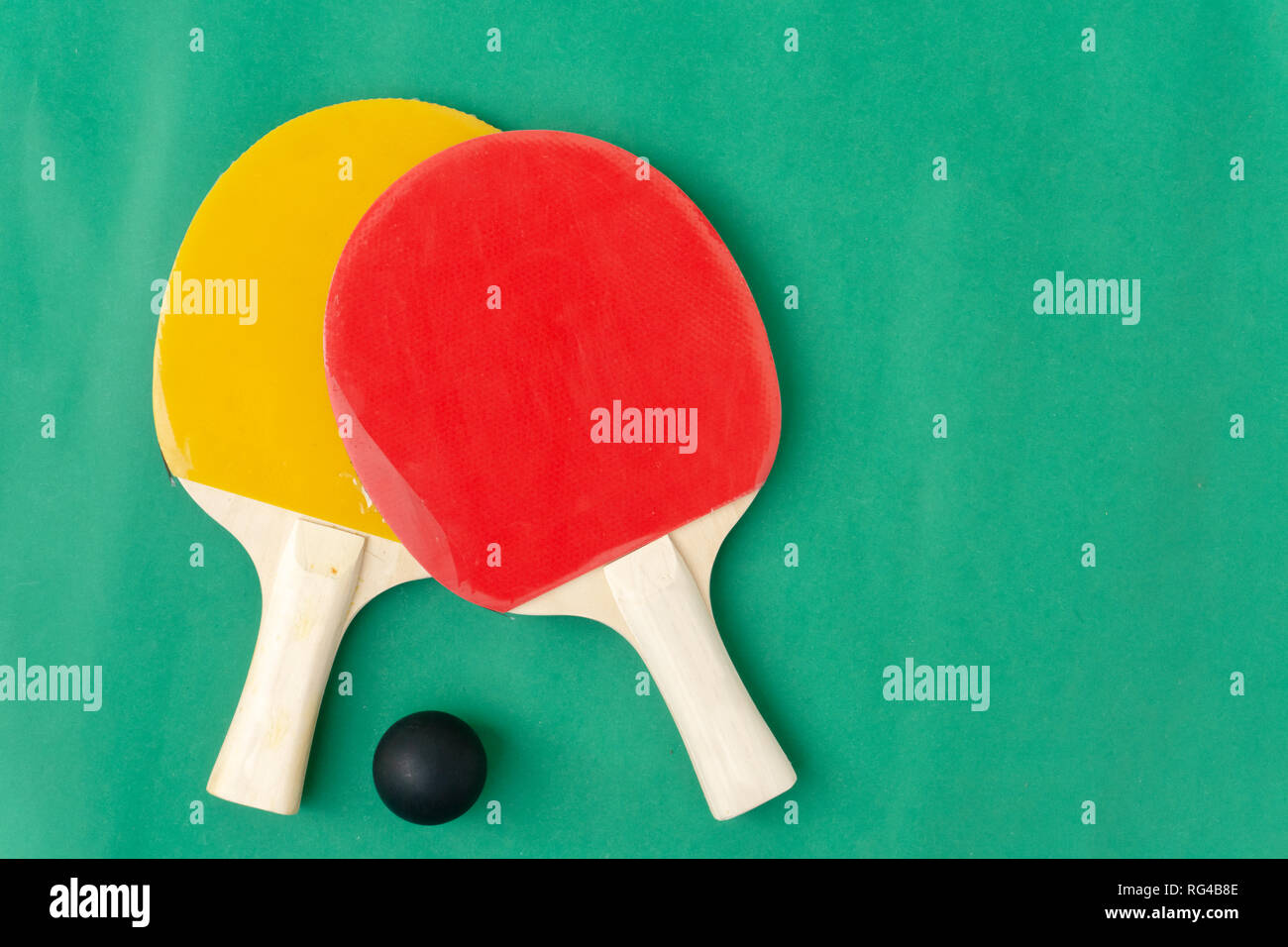 Red and yellow table tennis rackets with black balls, table tennis ...