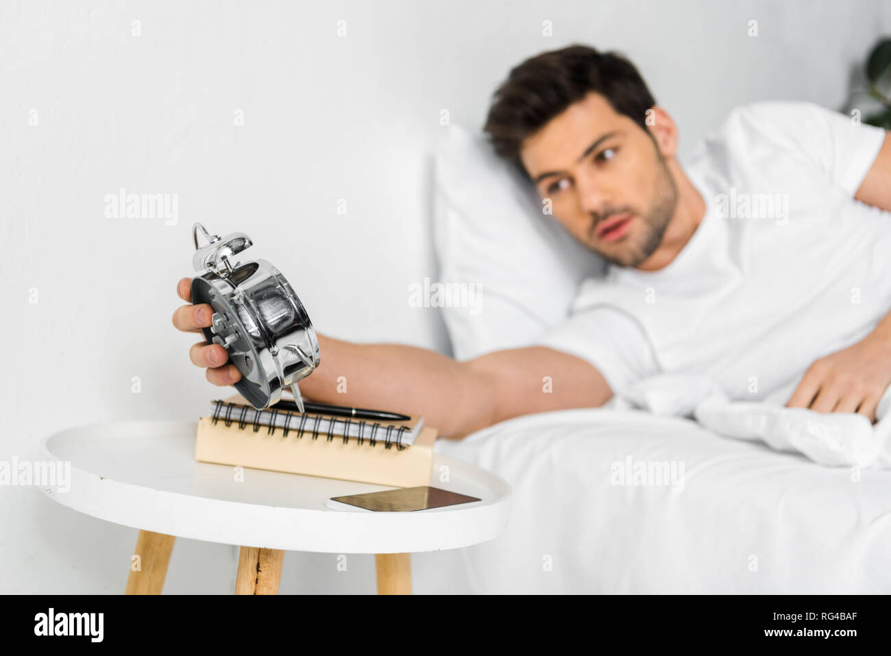 Selective focus man looking clock hi-res stock photography and images ...
