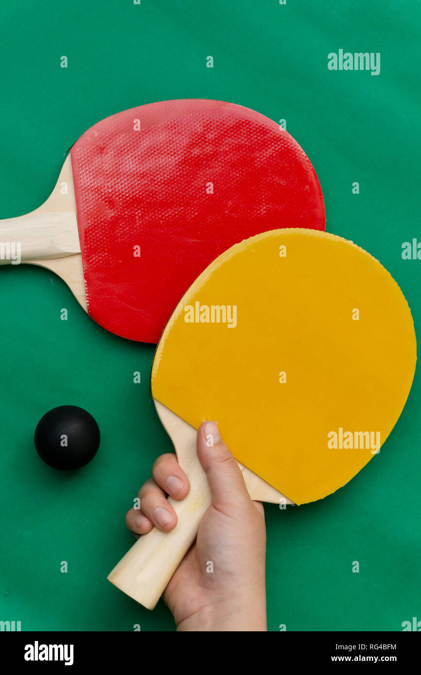 Red and yellow table tennis rackets with black balls, table tennis ...