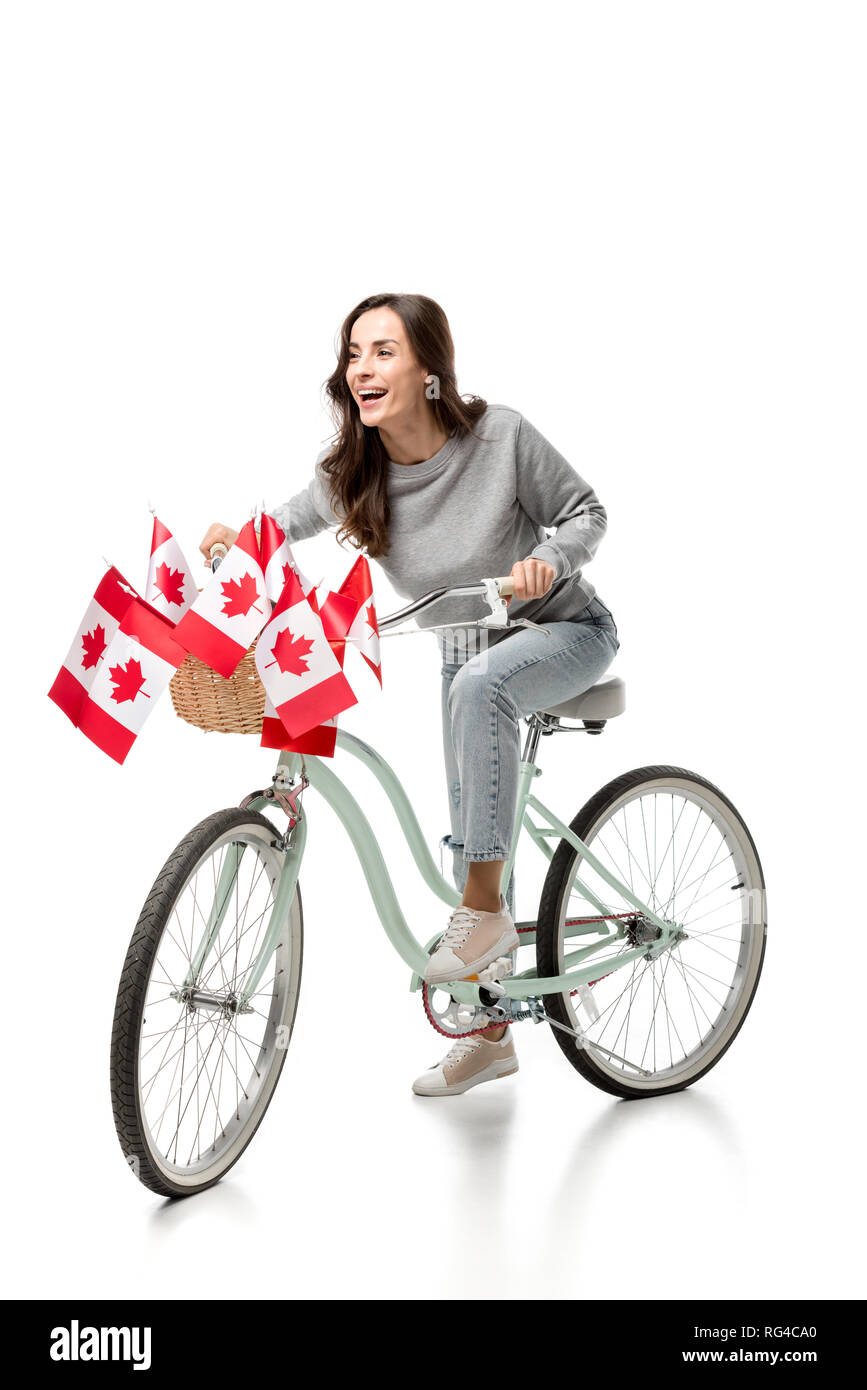 happy woman riding vintage bicycle with canadian flags isolated on ...