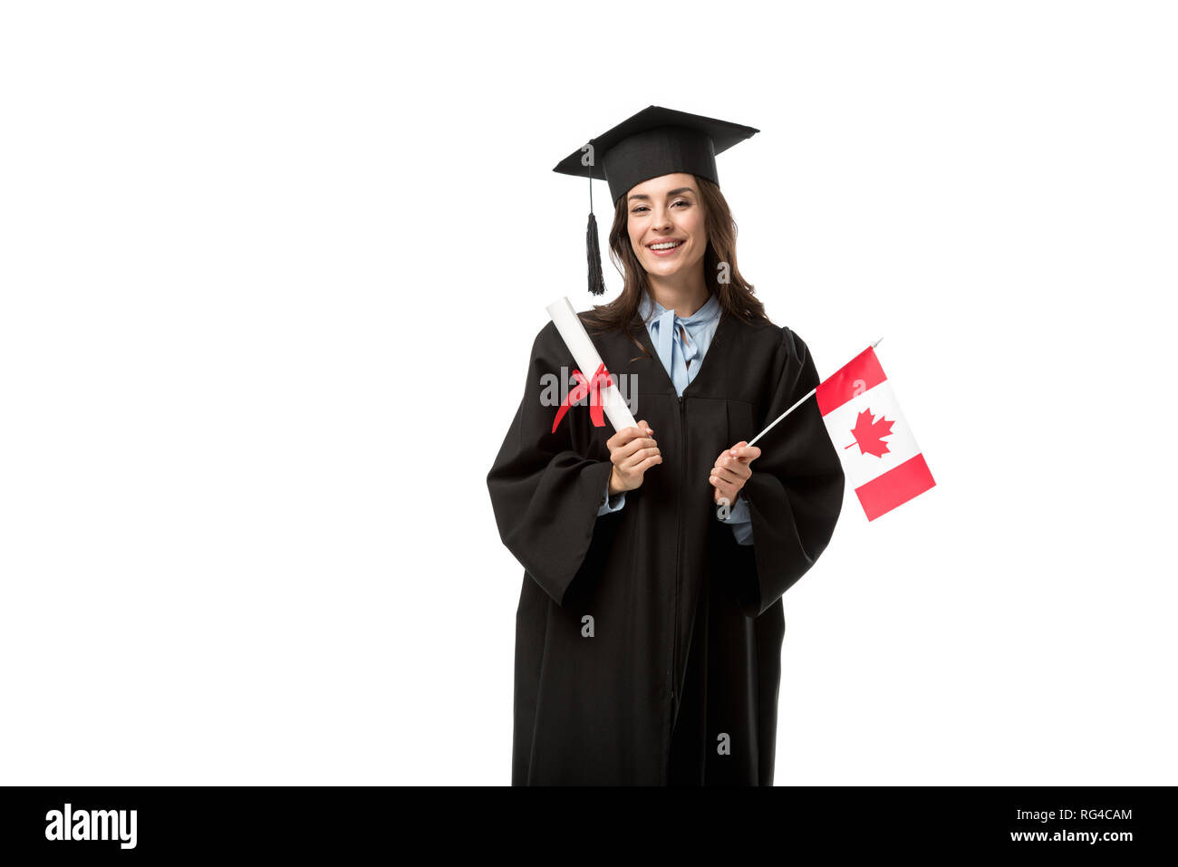 female student in academic gown looking at camera and holding canadian ...