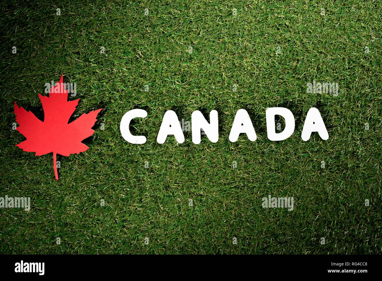 word 'Canada' with maple leaf on green grass background Stock Photo - Alamy