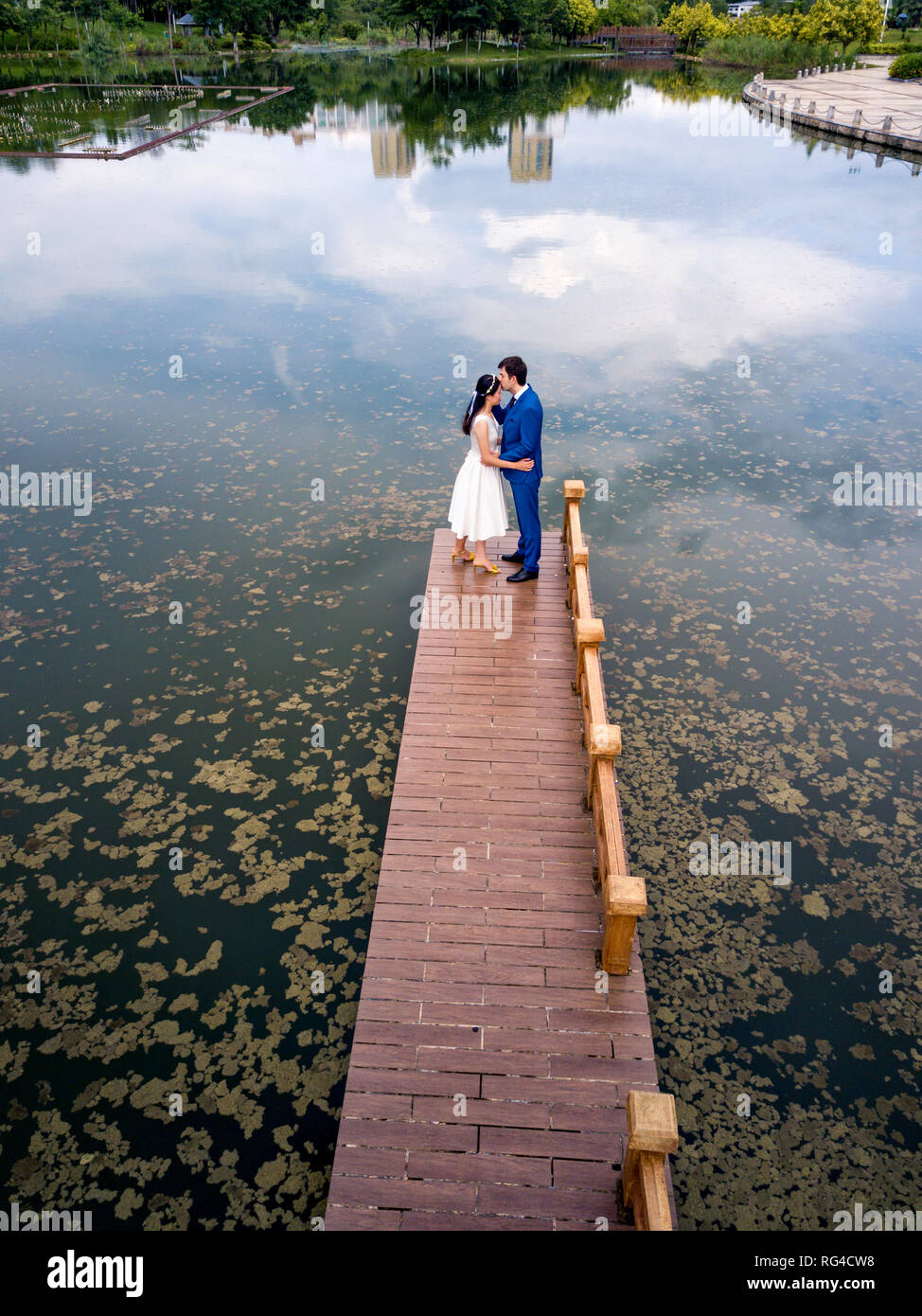 Romantic couple kissing in the park by the lake Stock Photo - Alamy