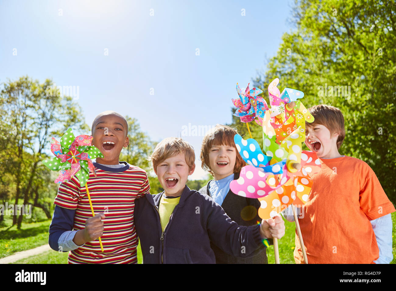 Multicultural children group in summer camp with colorful windmill ...