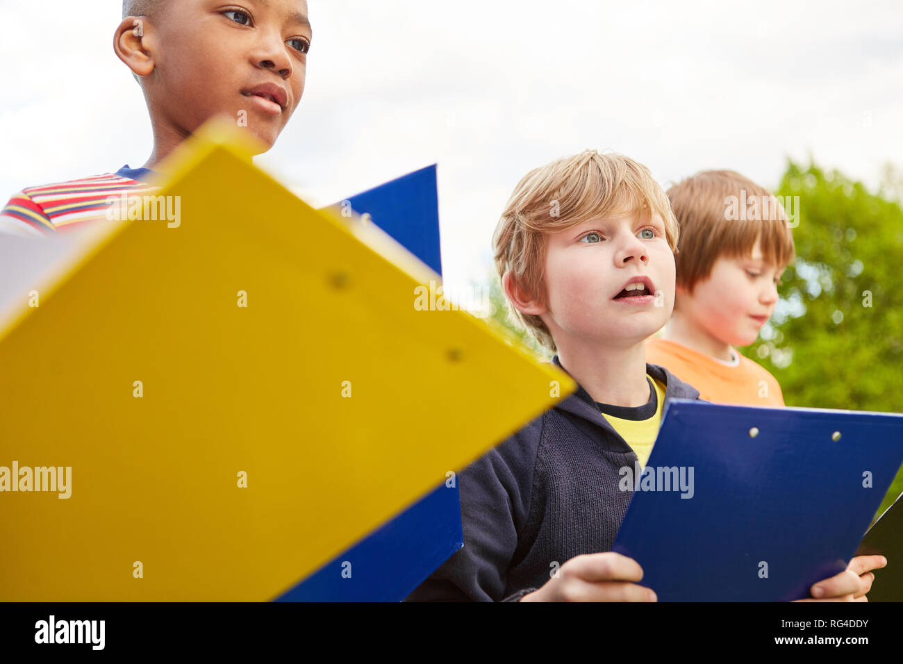 Children as elementary school students explore nature in a scavenger ...
