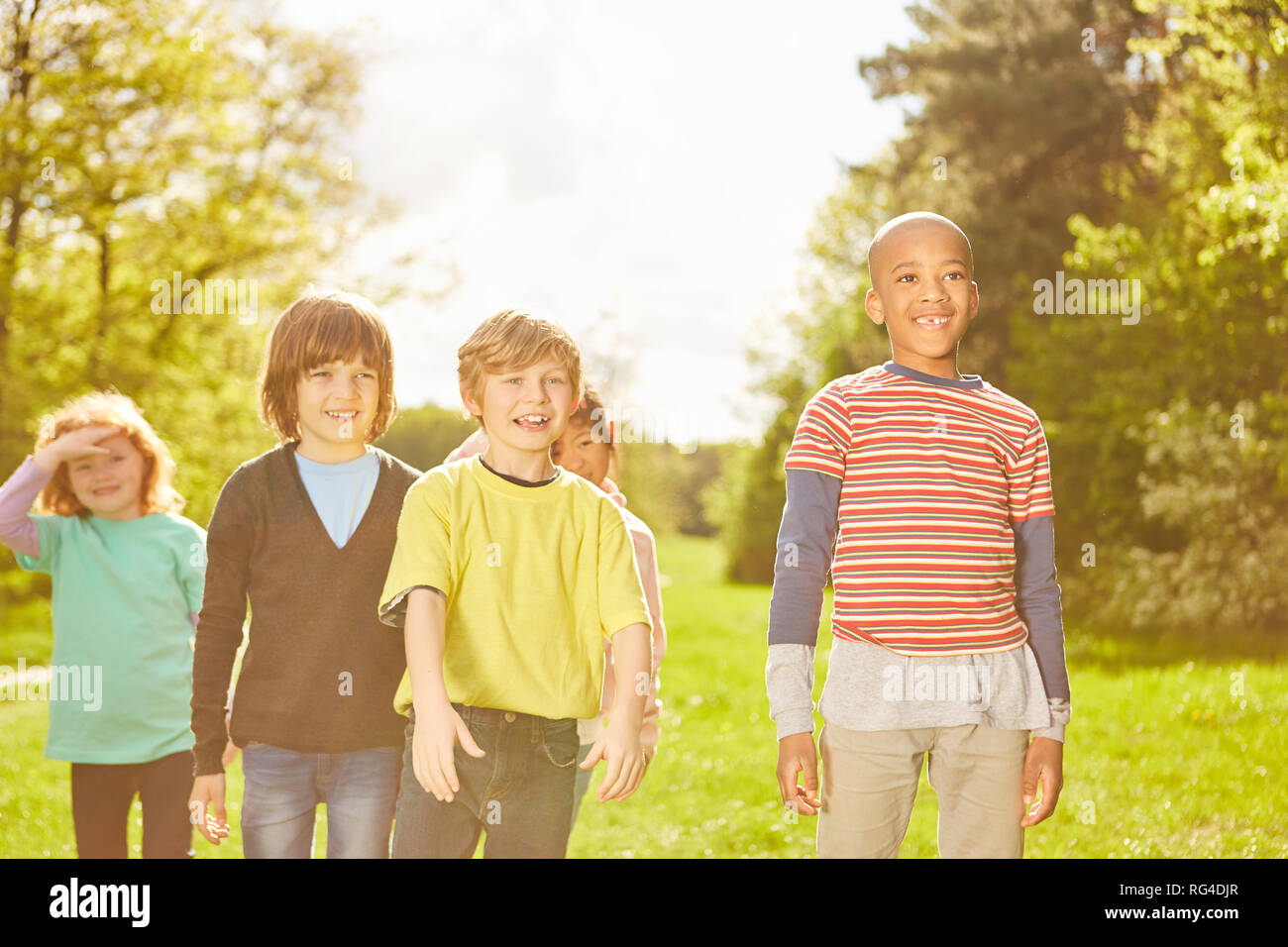 Group of children as friends in multicultural kindergarten in summer in ...