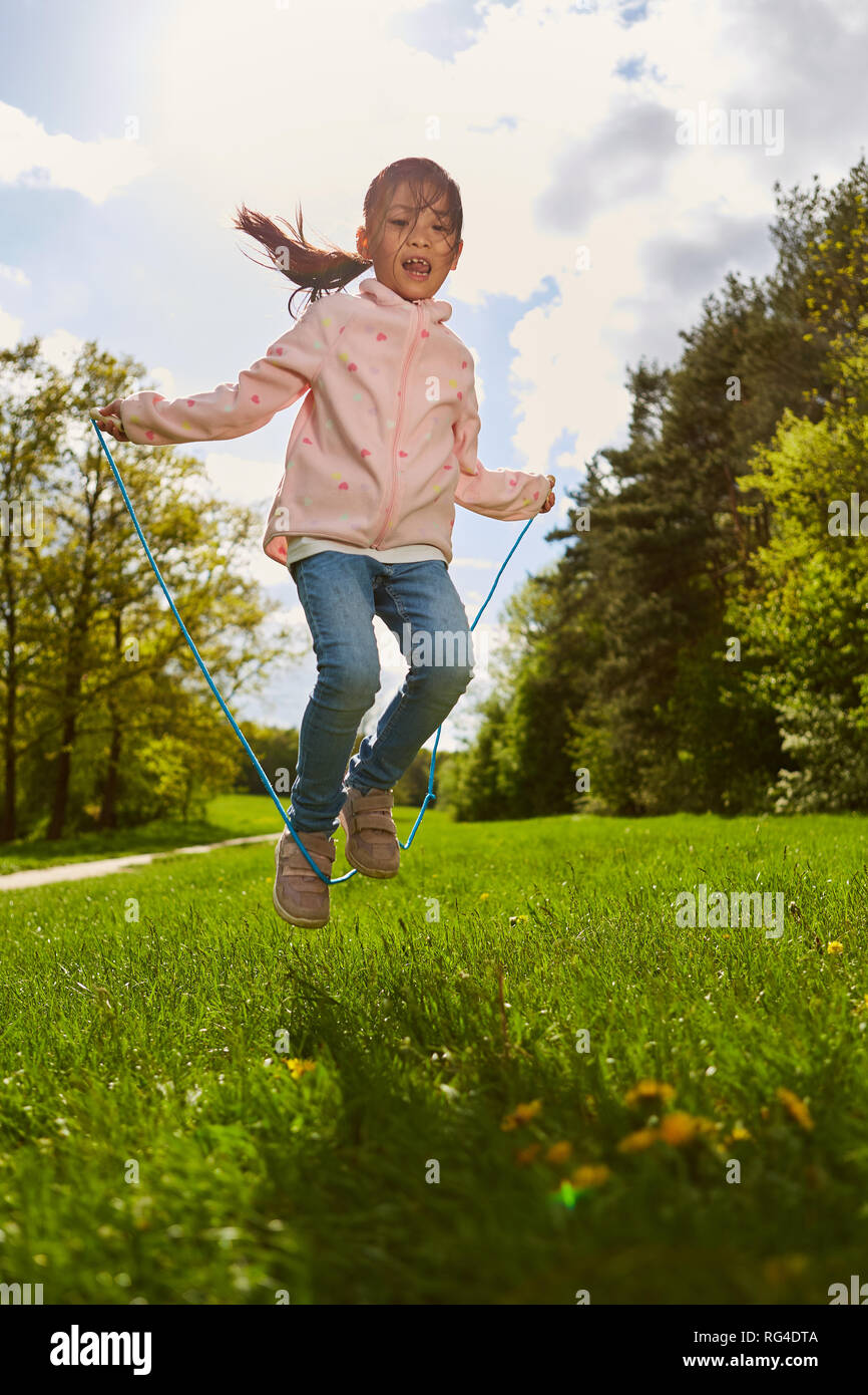 Happy girl skipping hi-res stock photography and images - Alamy