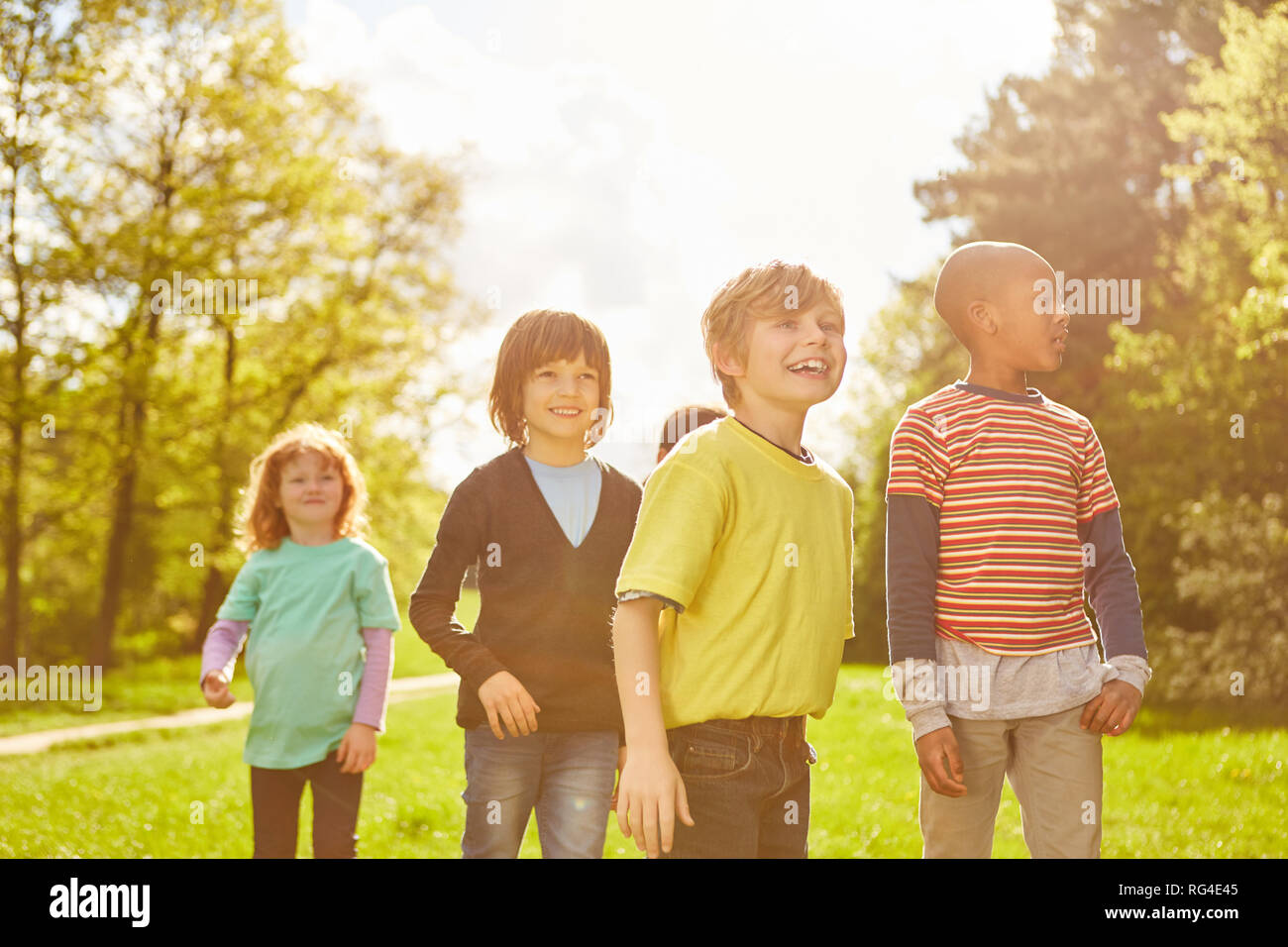 Happy children group makes a trip together in the summer in the park ...