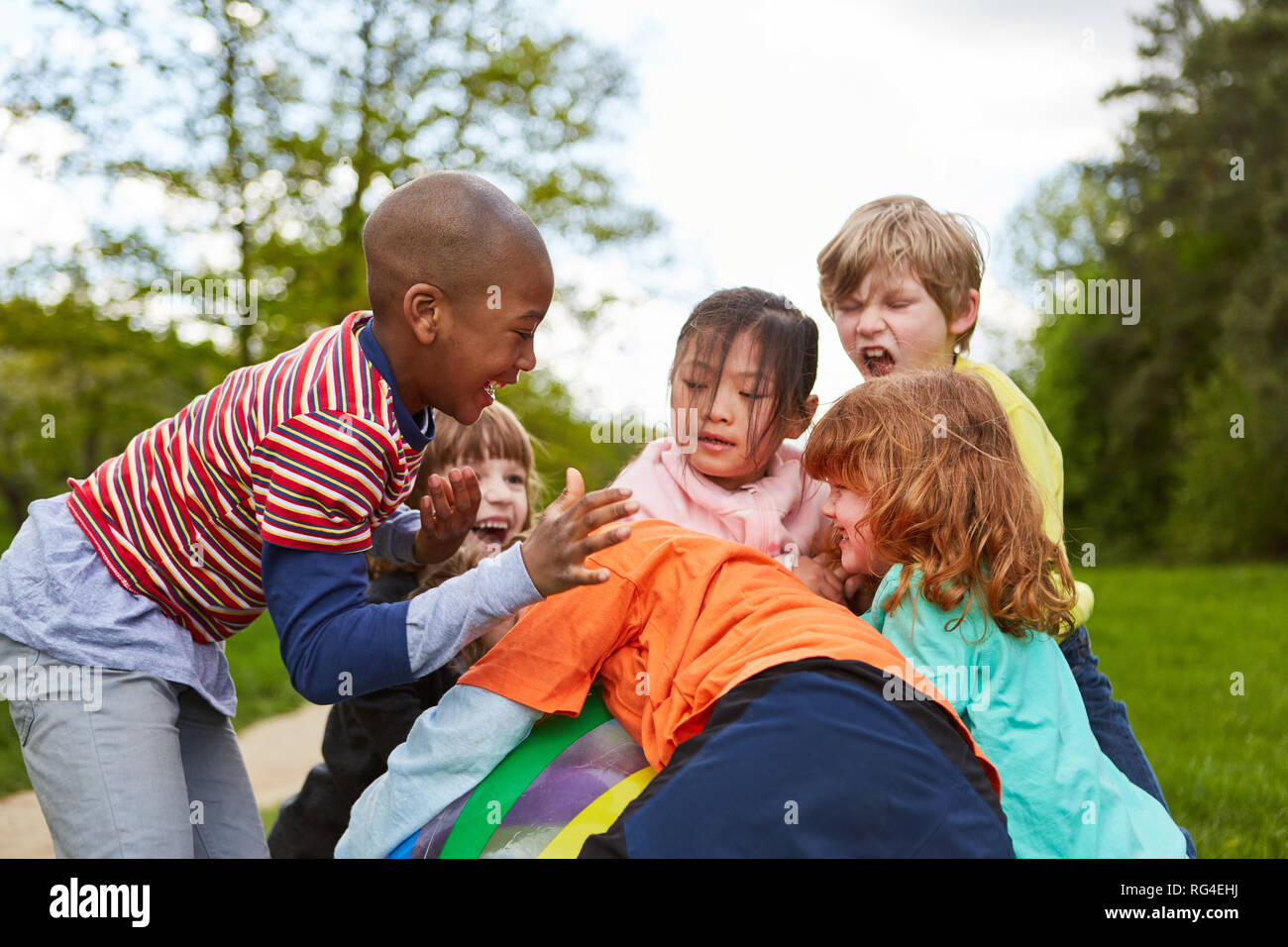 Multicultural children have fun in the park in the summer when ...