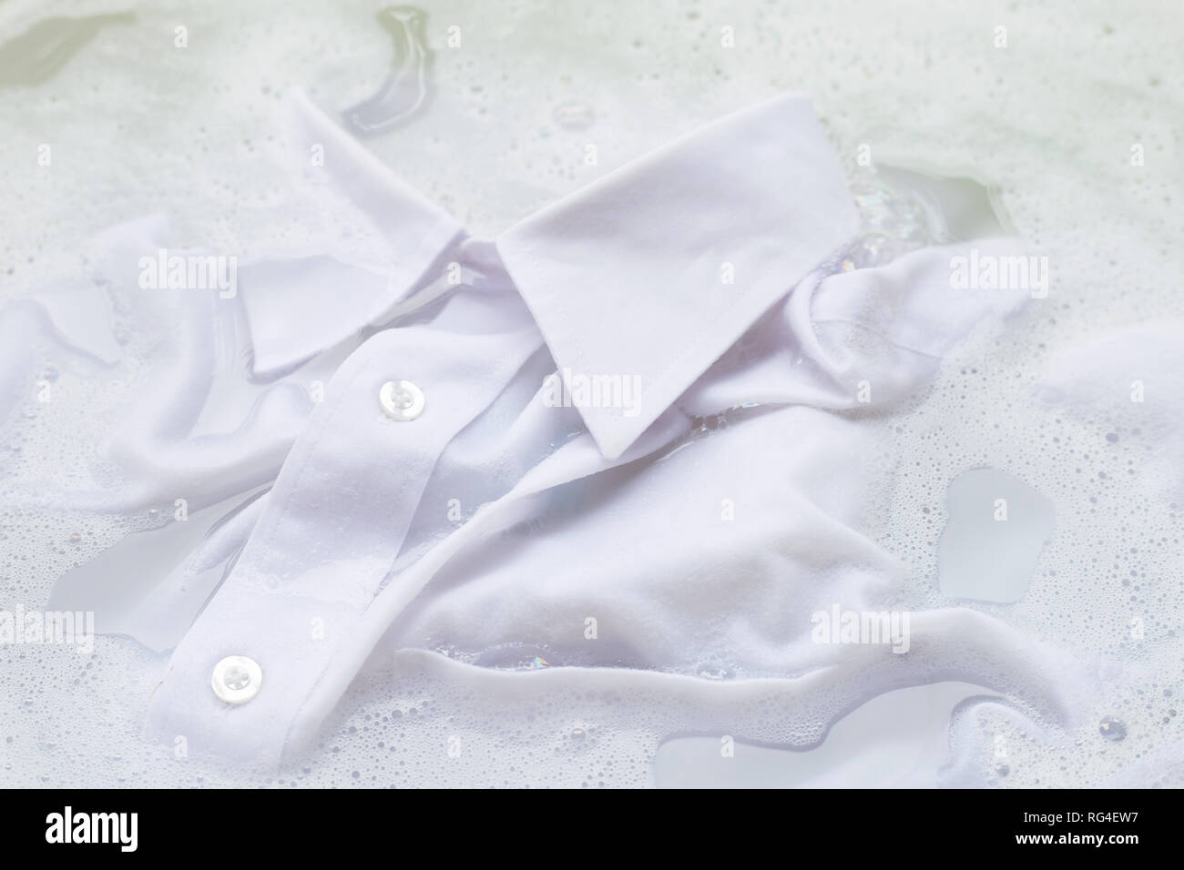 Soak a cloth before washing, white shirt Stock Photo - Alamy