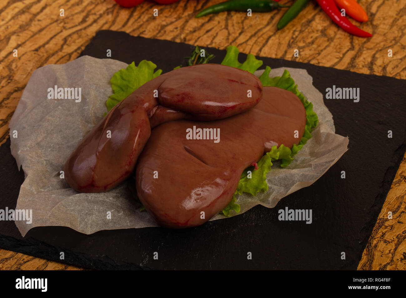 Raw pork kidneys ower wooden background Stock Photo - Alamy