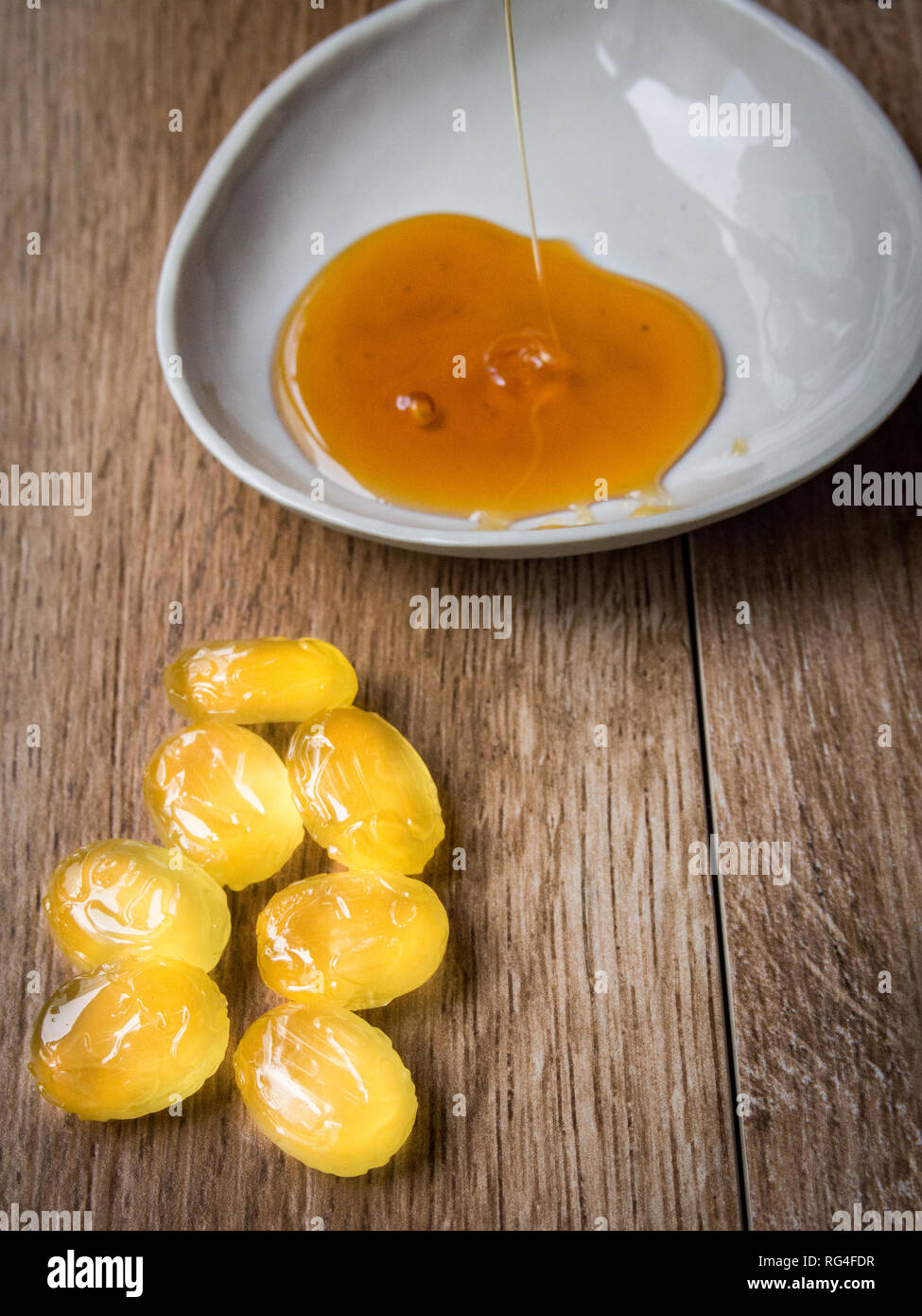 Honey candies on wood background Stock Photo - Alamy