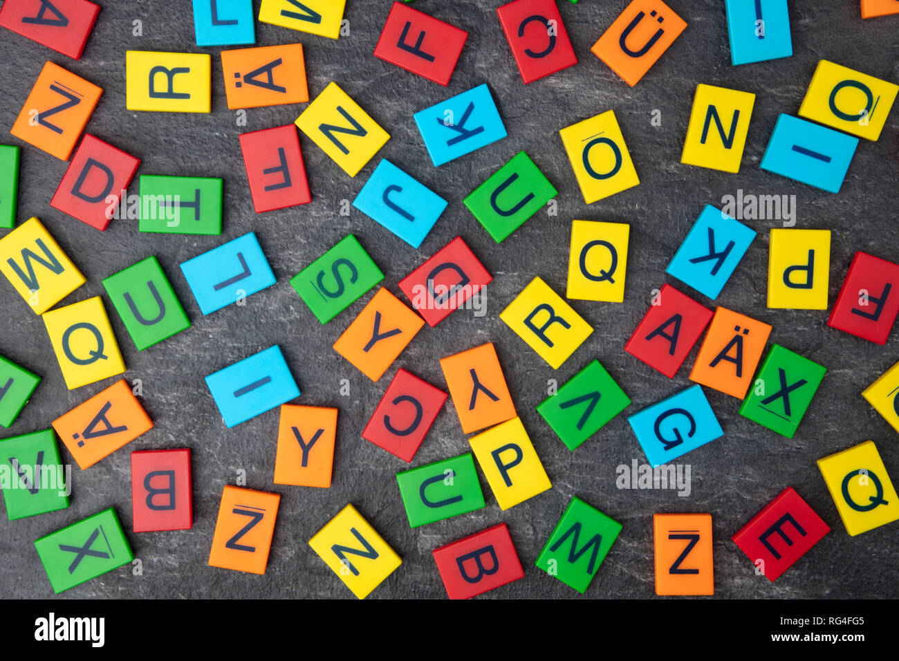 Colorful toy letters on dark background Stock Photo - Alamy