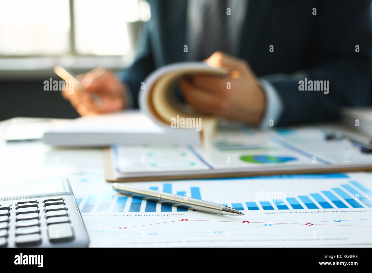 Silver calculator and financial statistics on clipboard Stock Photo - Alamy