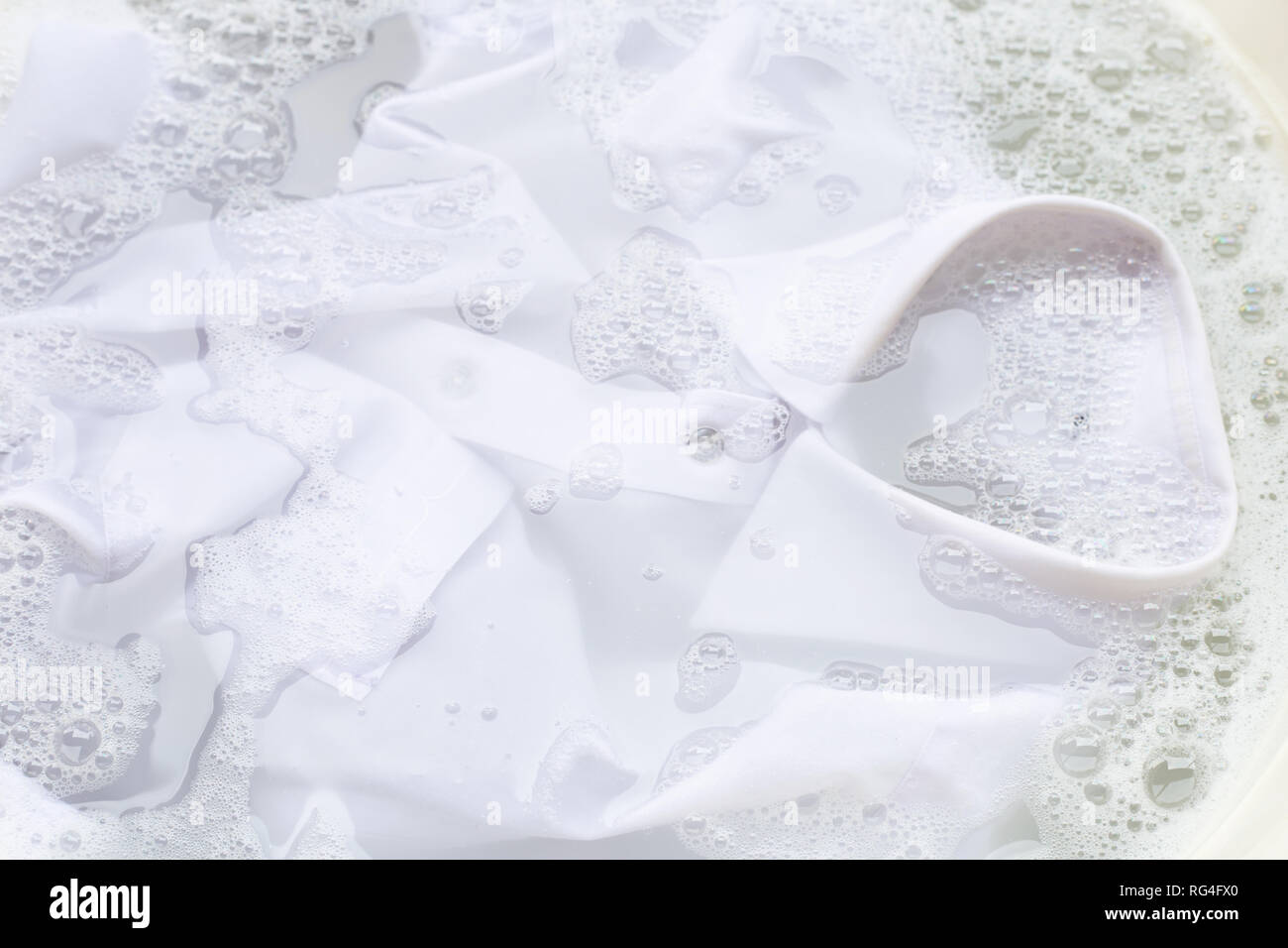 Soak a cloth before washing, white shirt Stock Photo - Alamy