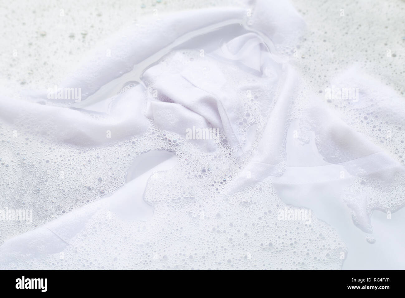 Soak a cloth before washing, white shirt Stock Photo - Alamy