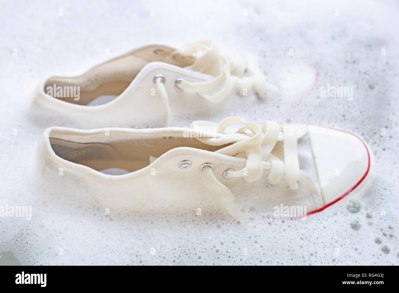 Soak shoes before washing. Cleaning Dirty sneakers Stock Photo - Alamy