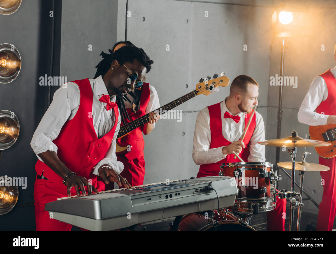 gorgeous group of young people enjoys playing the instruments Stock ...