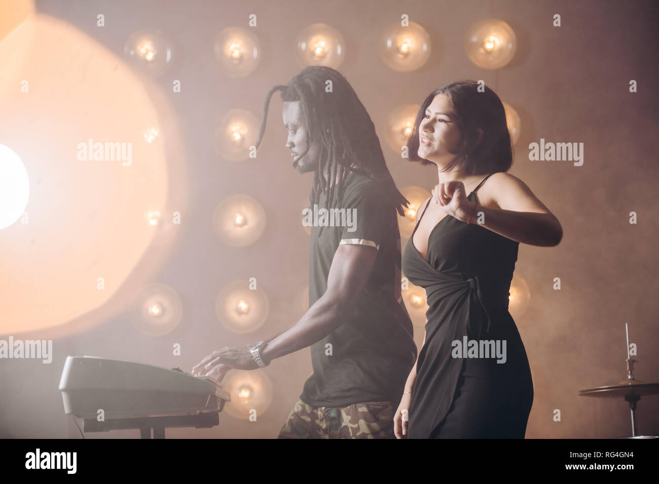 beautiful vocalist girl is singing on the stage Stock Photo - Alamy