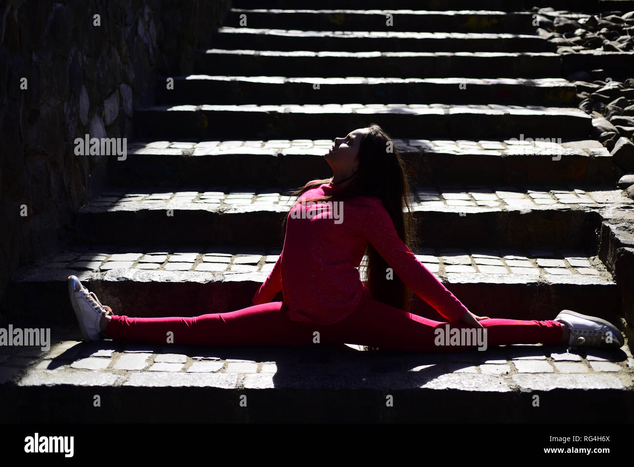 Getting her muscles flexible. Little girl doing split. Fitness and ...