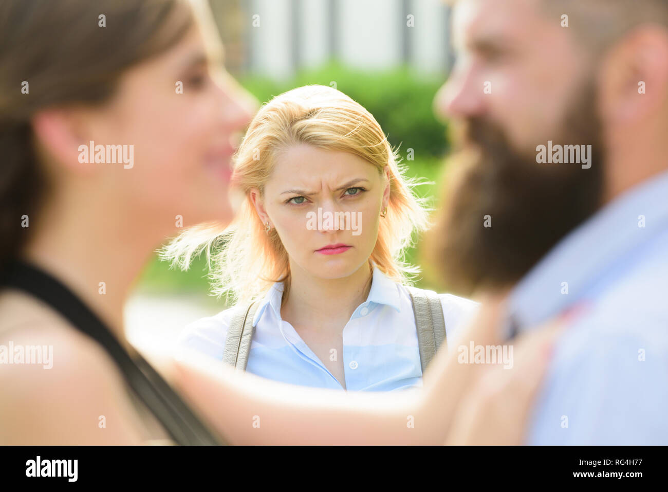 Going into a jealous rage. Jealous woman look at couple in love on ...
