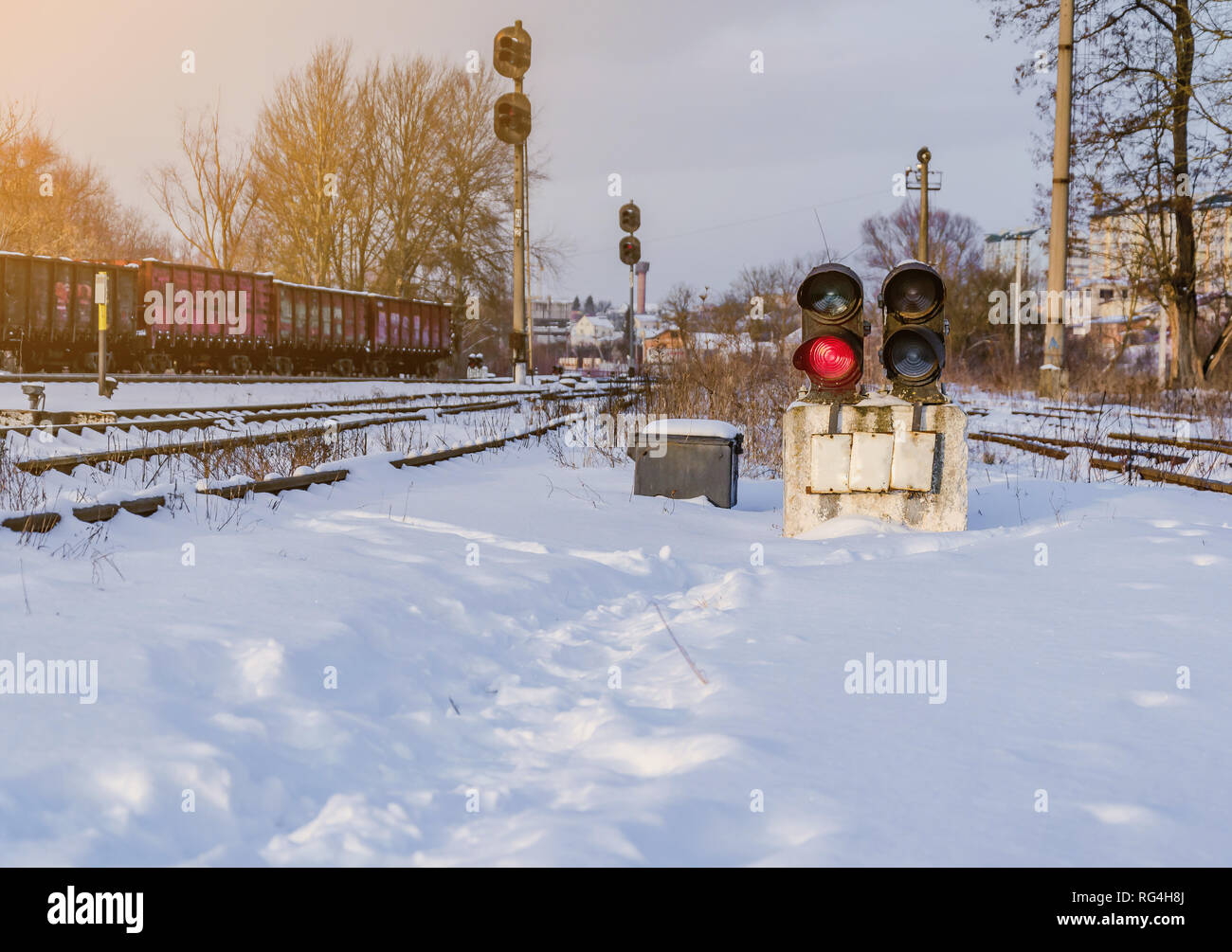 Vintage railway traffic light on old snow covered railway station ...