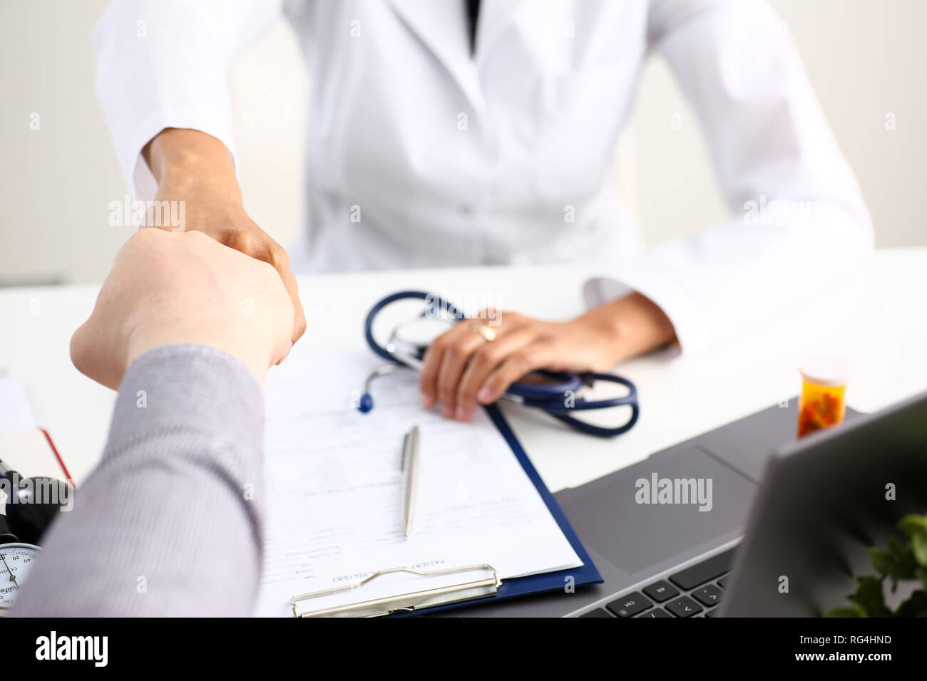 Doctor shake hand as hello with patient Stock Photo - Alamy